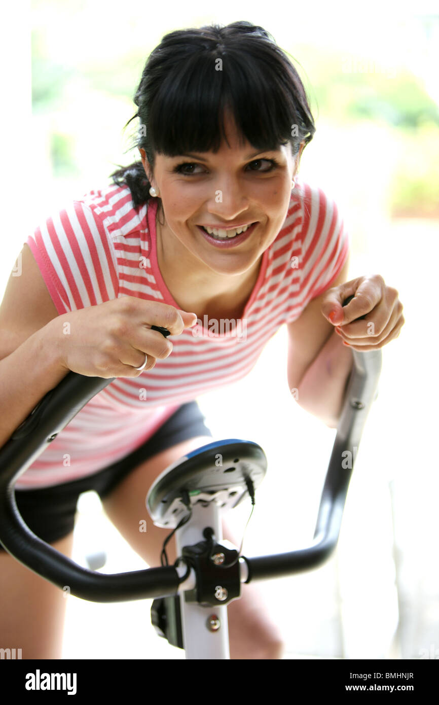 Young Woman Riding Exercise Bike. Model Released Stock Photo - Alamy