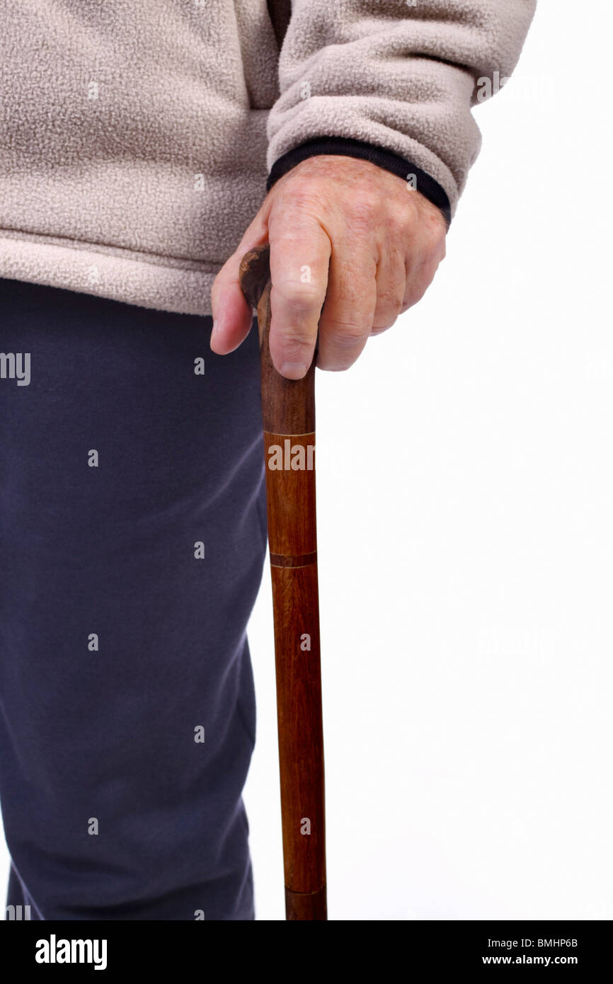 Mature man standing holding a walking stick Stock Photo - Alamy