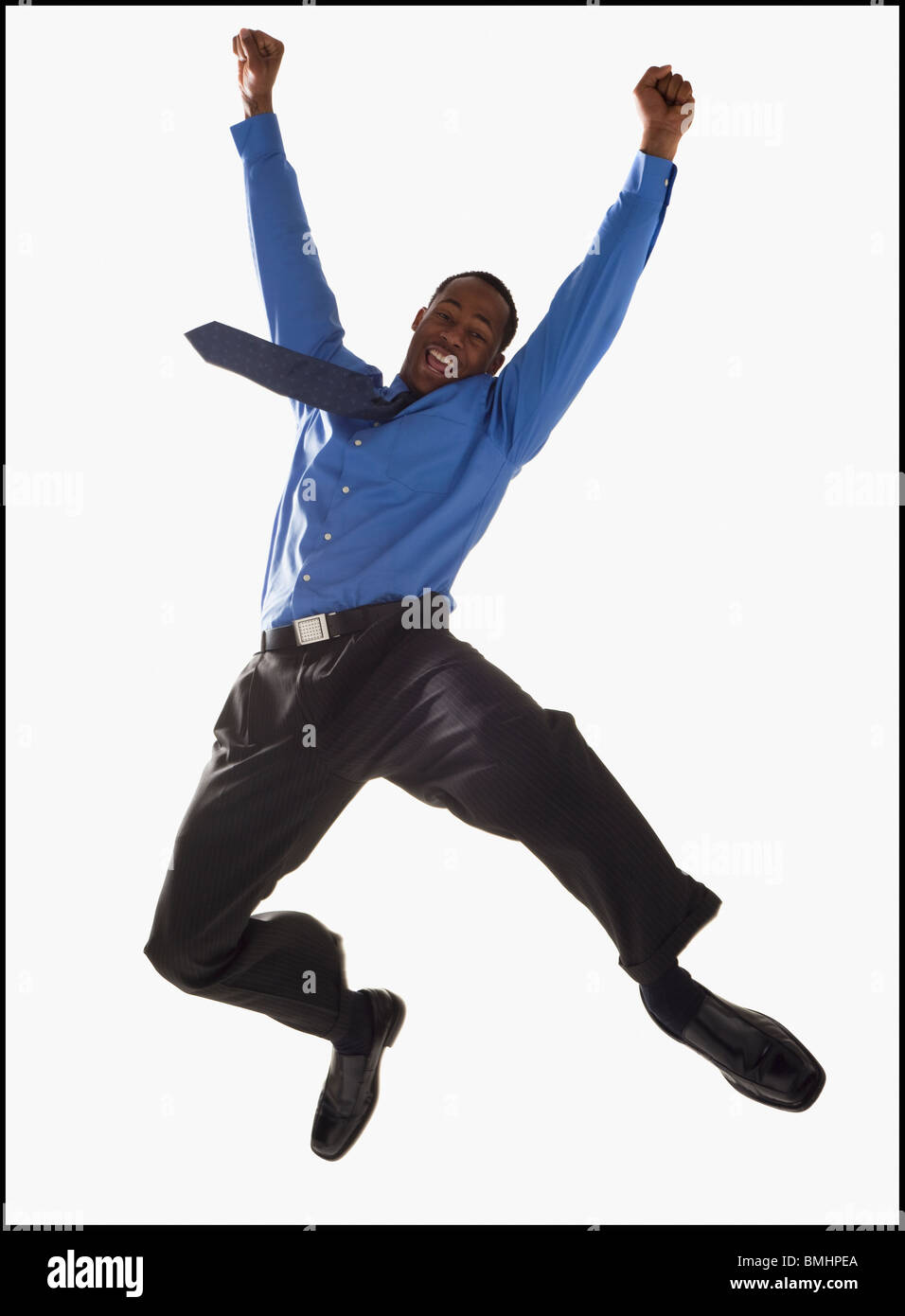 Excited businessman jumping Stock Photo - Alamy