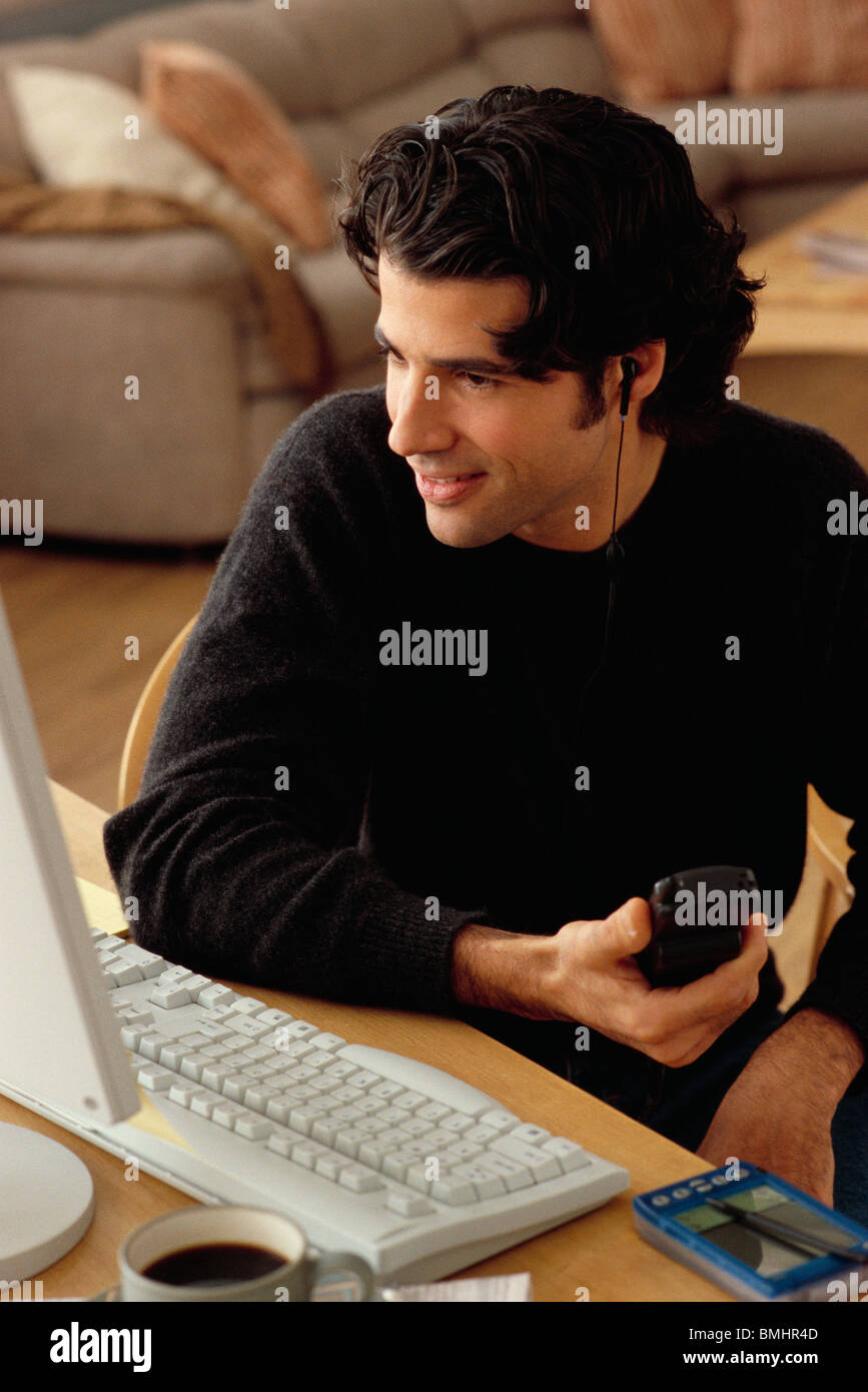 Man looking at home computer Stock Photo - Alamy