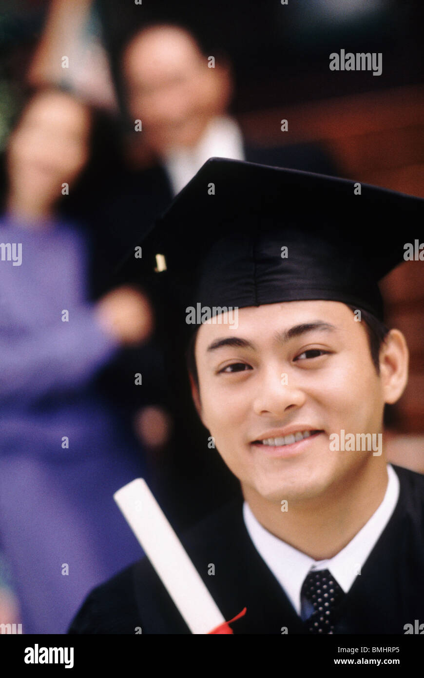 Graduate holding his diploma Stock Photo - Alamy