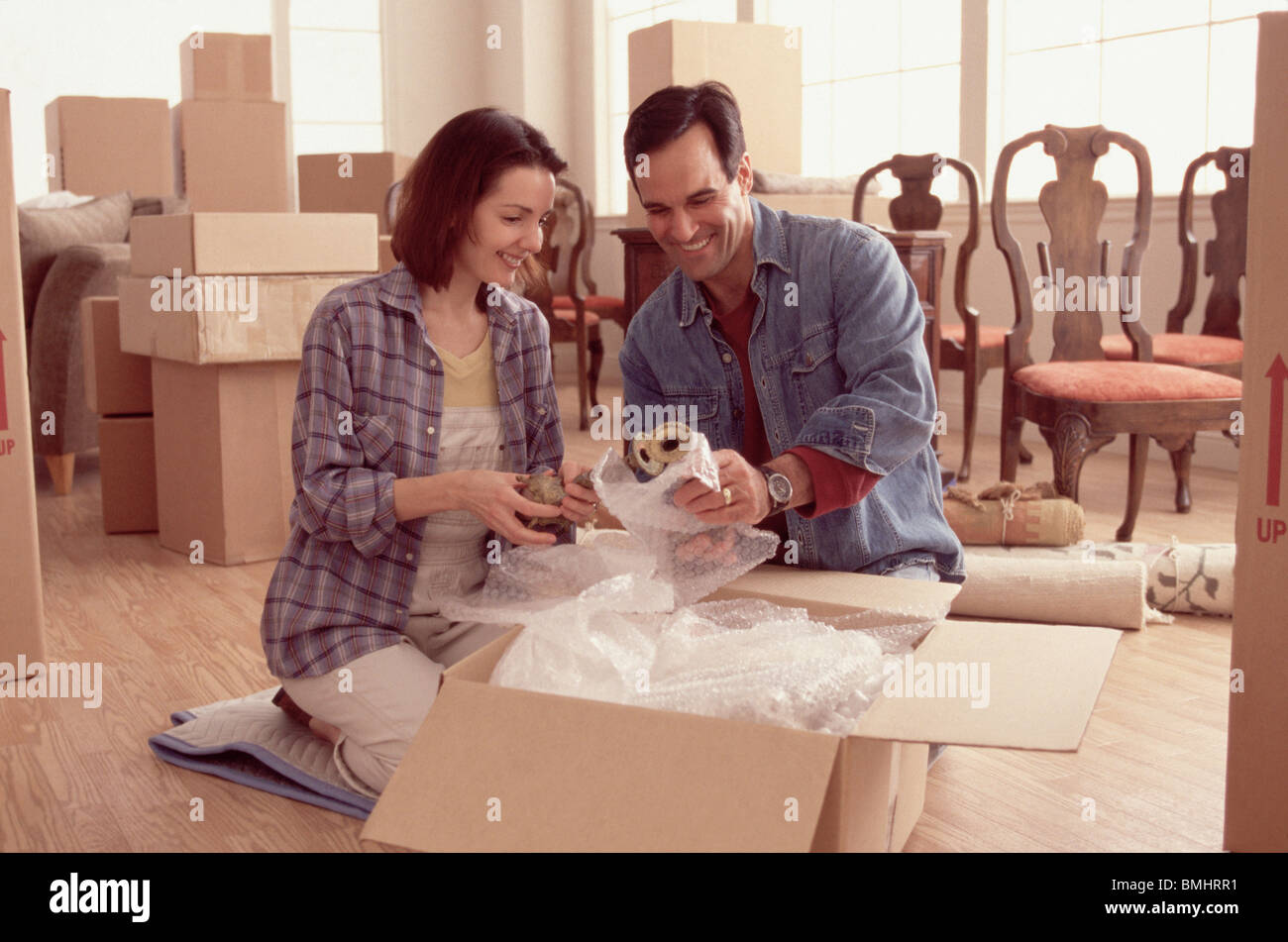 Couple unpacking together Stock Photo - Alamy