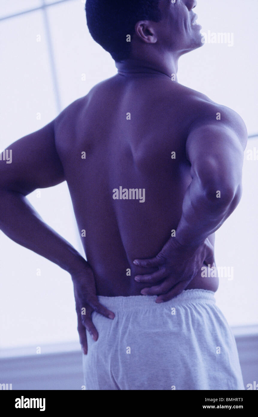Man with a strained back Stock Photo - Alamy
