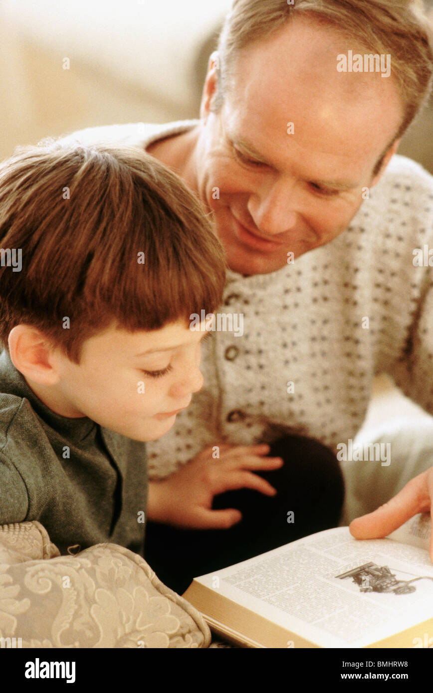 Father and son reading together Stock Photo - Alamy