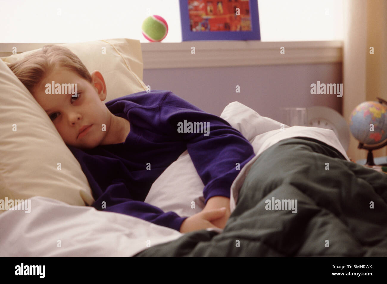 Young boy sick in bed Stock Photo - Alamy