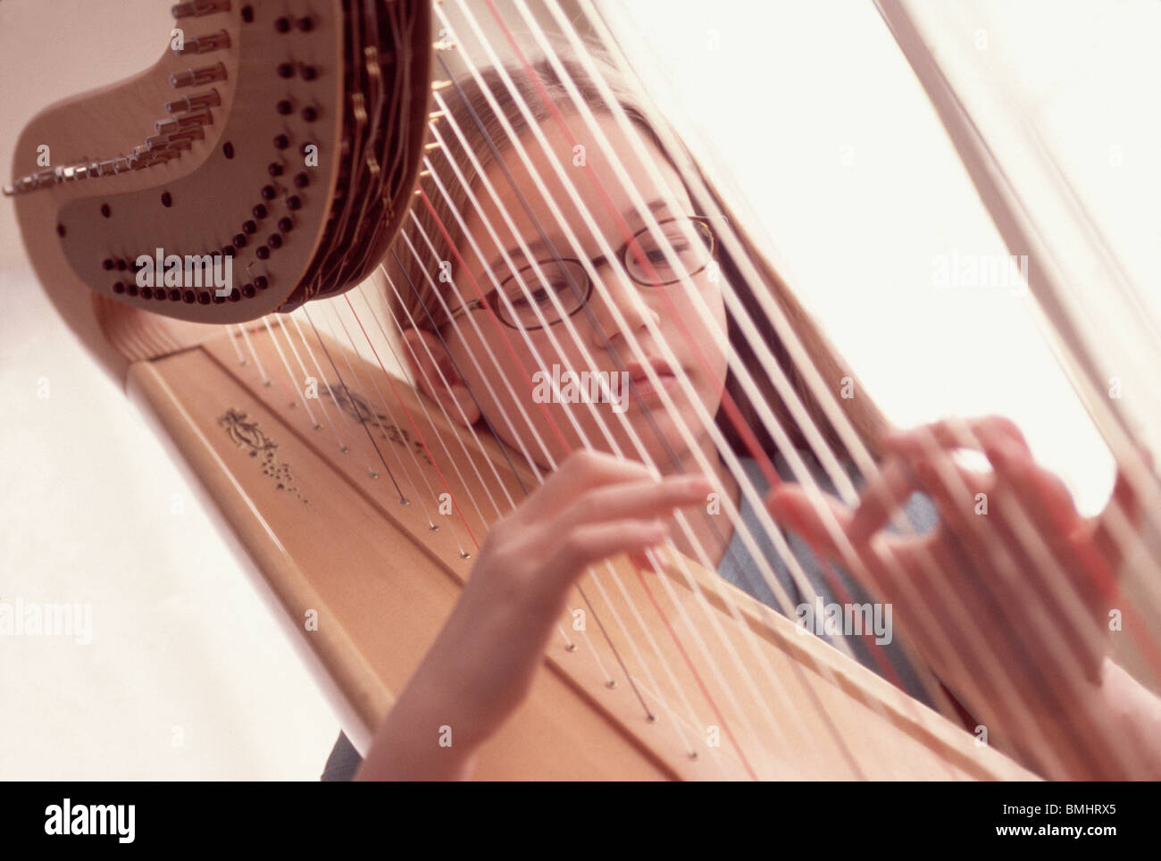 Young girl playing the harp Stock Photo - Alamy