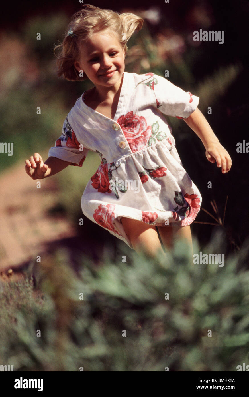 Young girl running outside Stock Photo - Alamy