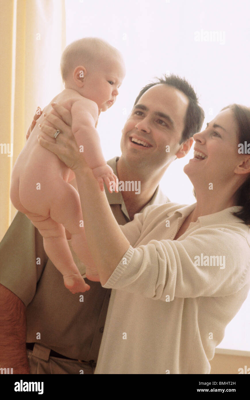 Mother and father admiring their newborn baby Stock Photo - Alamy