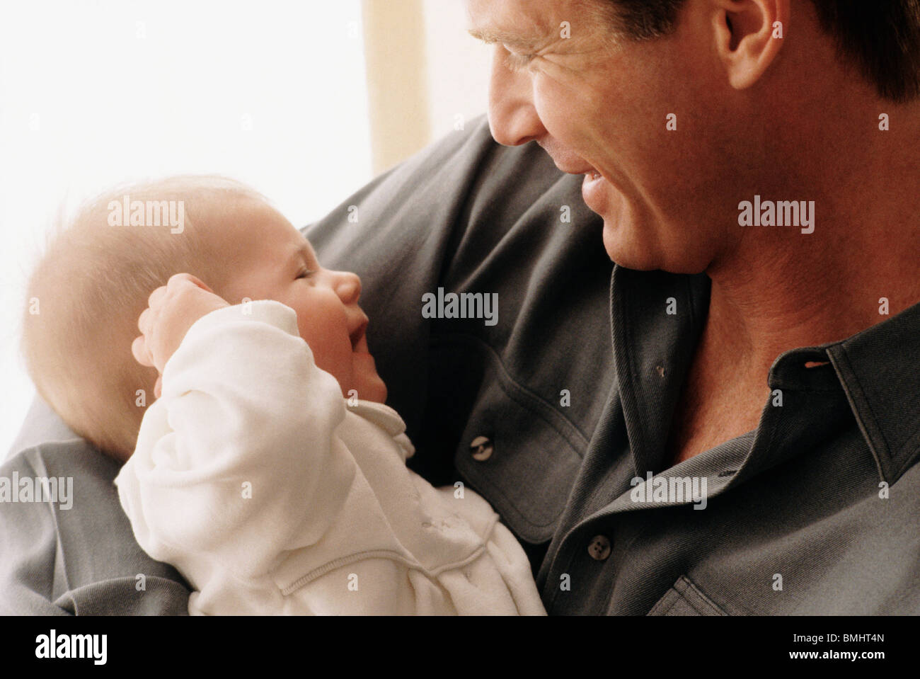 Father smiling at his baby Stock Photo - Alamy