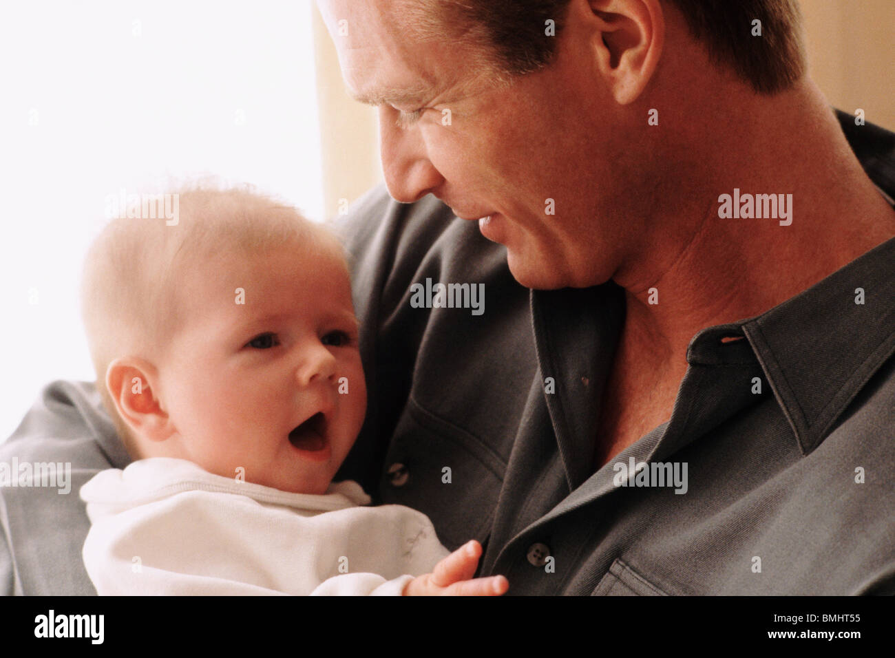 Father smiling at his baby Stock Photo - Alamy