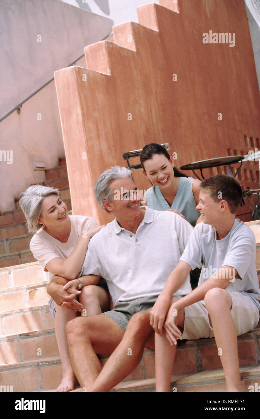 Family sitting on steps together Stock Photo - Alamy