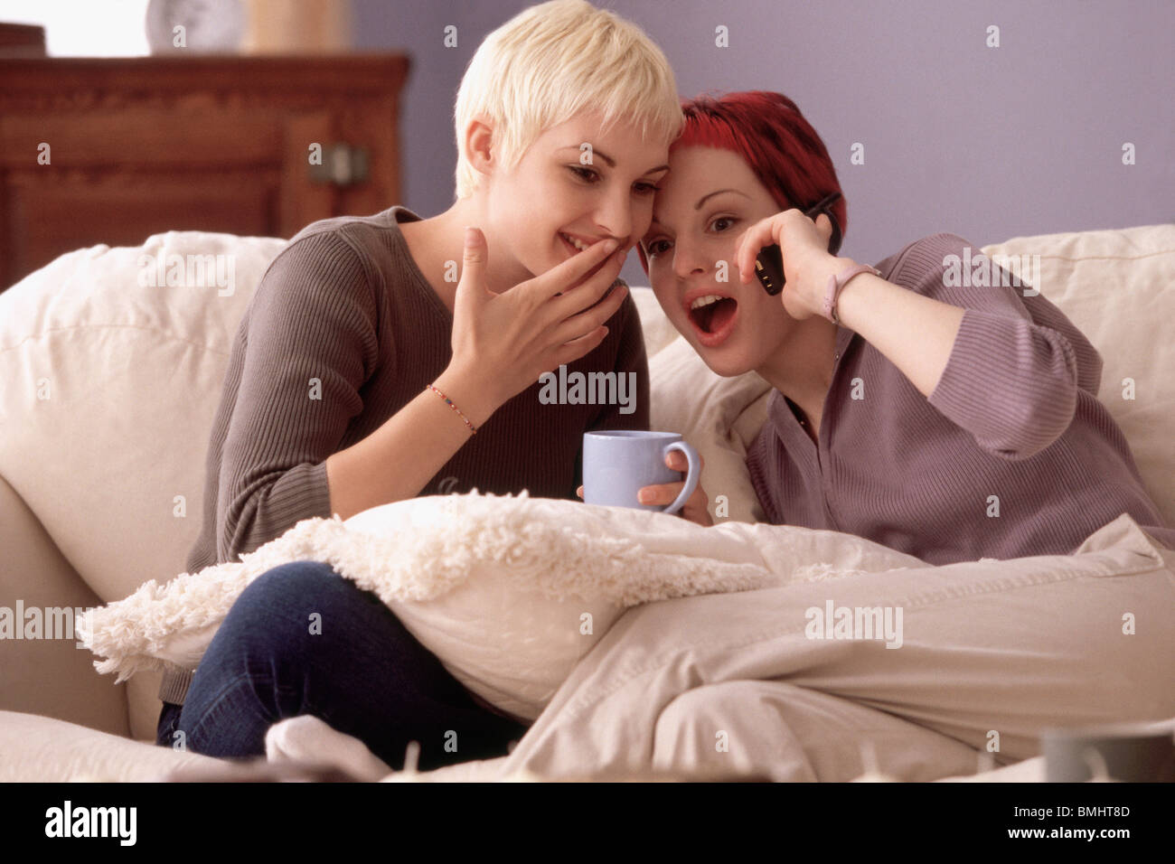 Surprised woman laughing together Stock Photo - Alamy