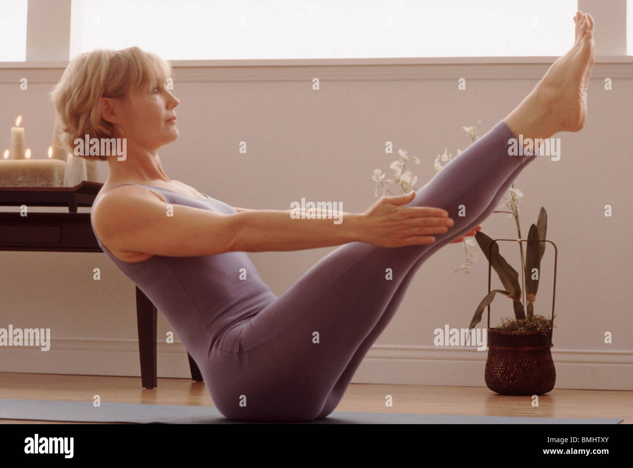 Woman doing a yoga pose Stock Photo - Alamy
