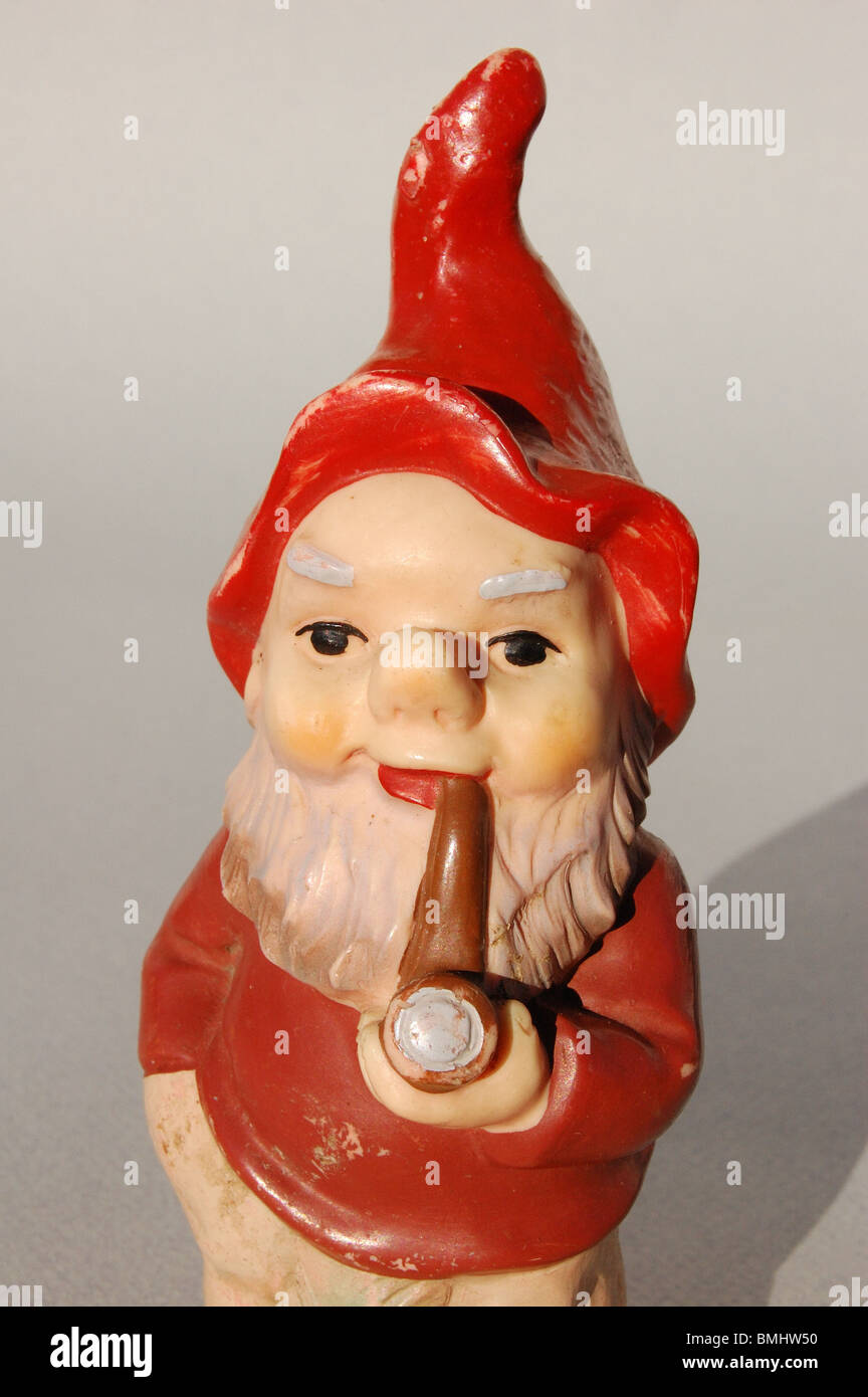 plastic garden gnome smoking a pipe Stock Photo - Alamy
