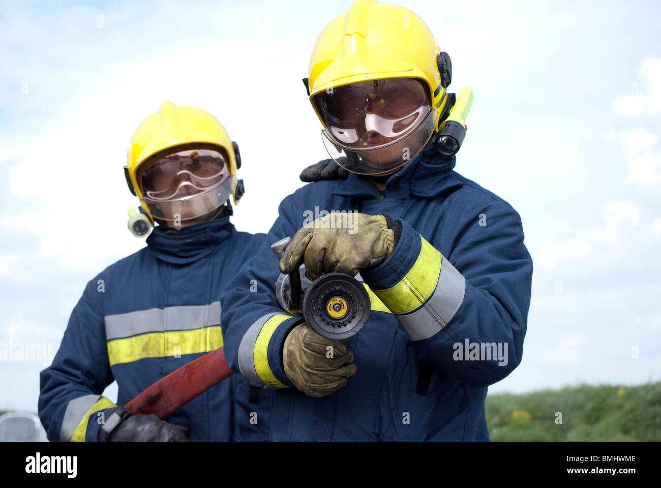 Two firefighters ready for action Stock Photo - Alamy