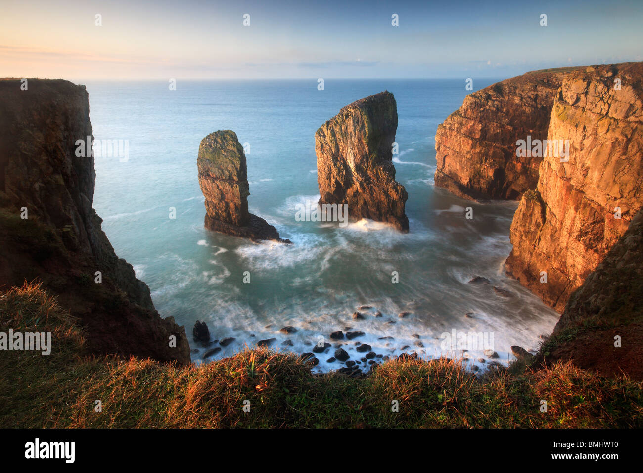 The Elegug Stacks at dawn on a winter's morning along the Pembrokeshire ...