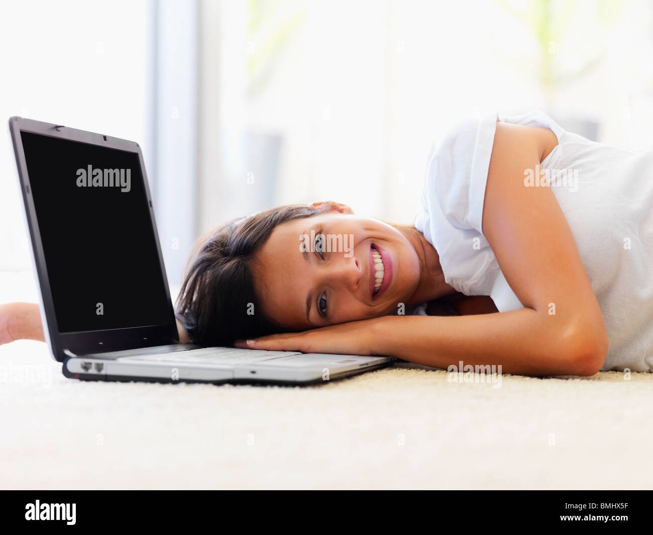 Woman resting beside laptop Stock Photo - Alamy