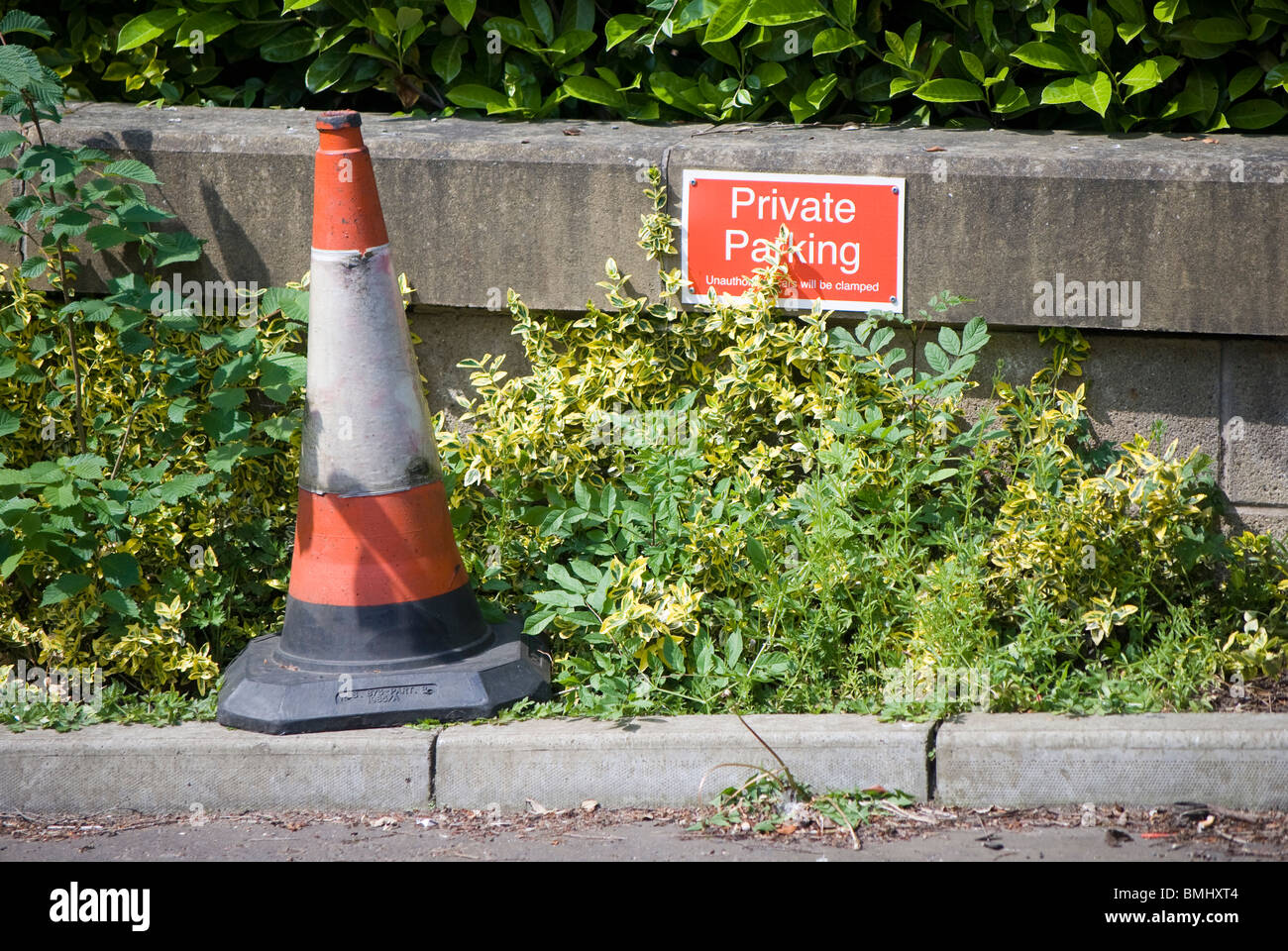 Parking cone and sign marking a private parking space in the centre of ...