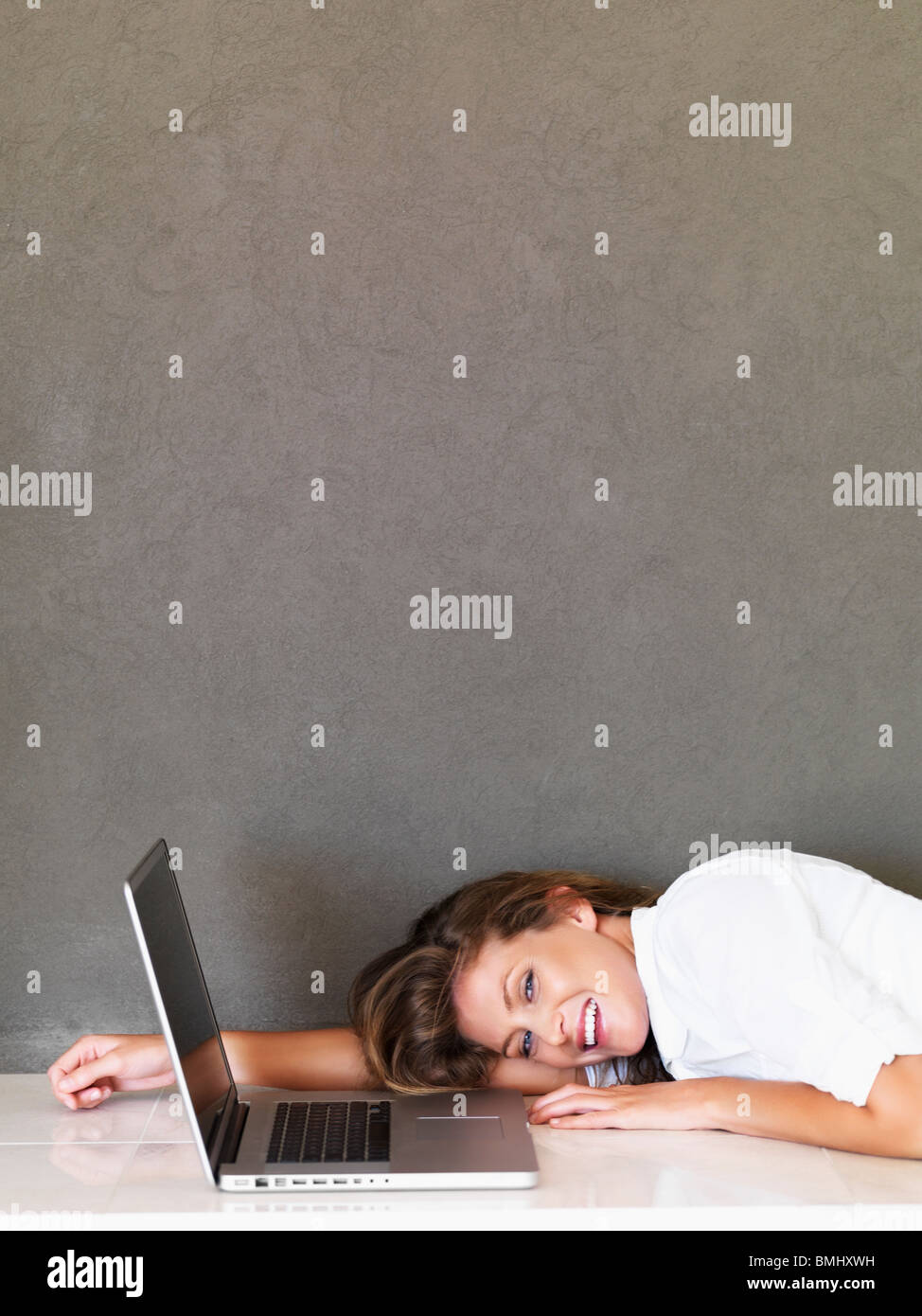 Tired woman in front of laptop Stock Photo - Alamy