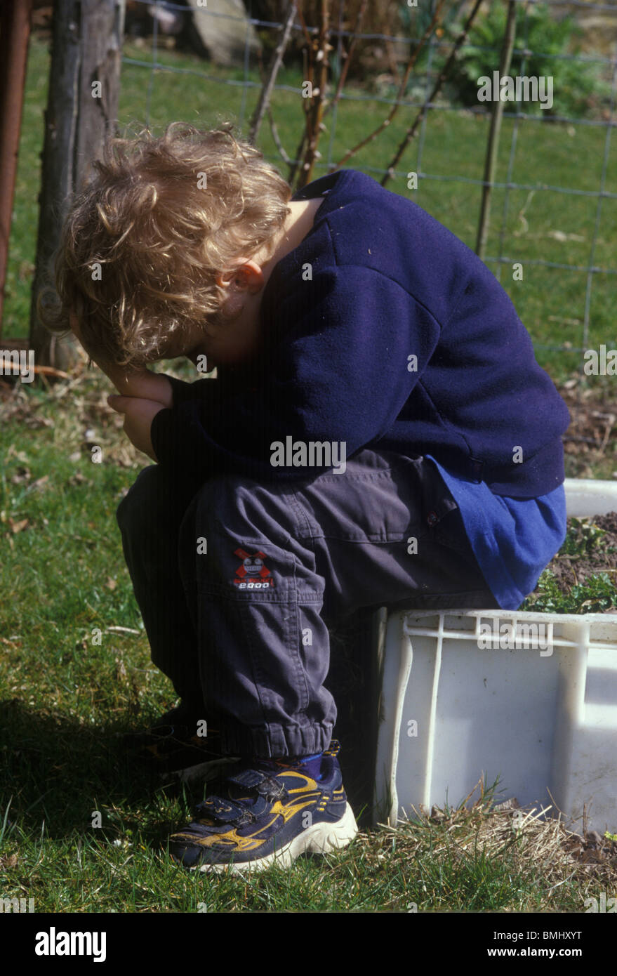 little boy looking sad and moody Stock Photo - Alamy