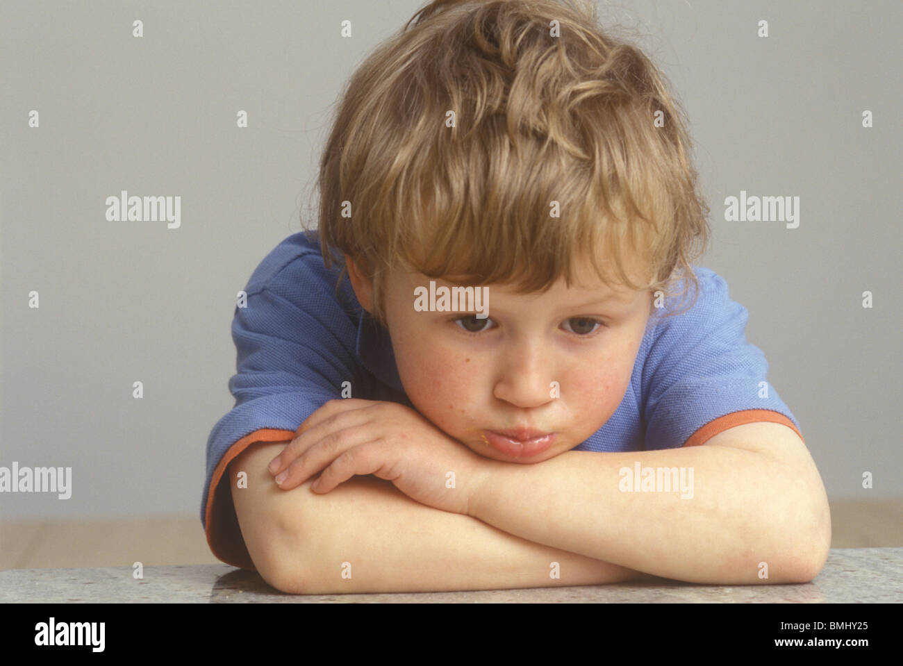little boy looking sad and moody Stock Photo - Alamy