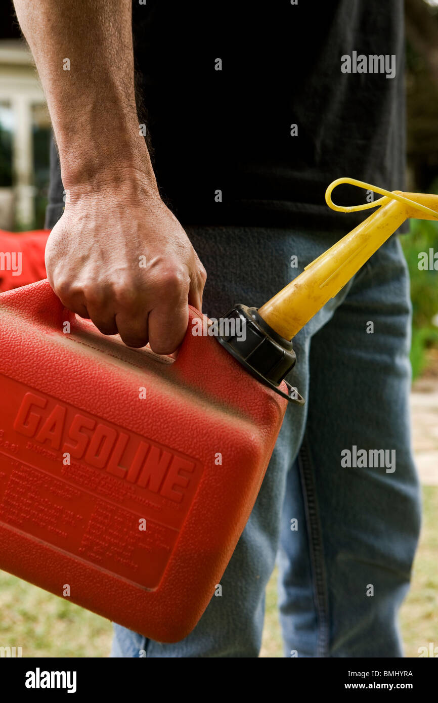 Hand holding gas can Stock Photo - Alamy