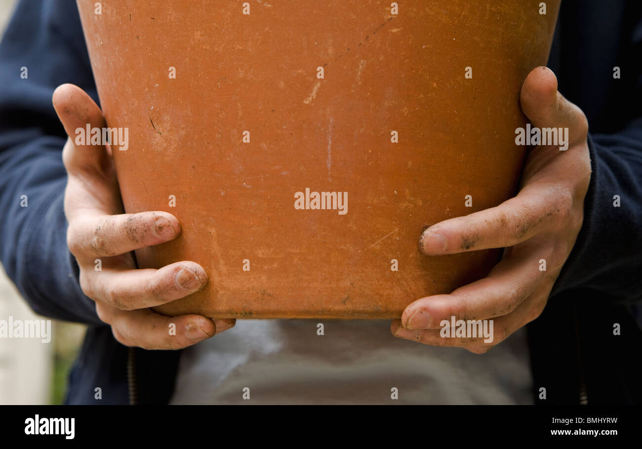Hands holding clay pot Stock Photo - Alamy