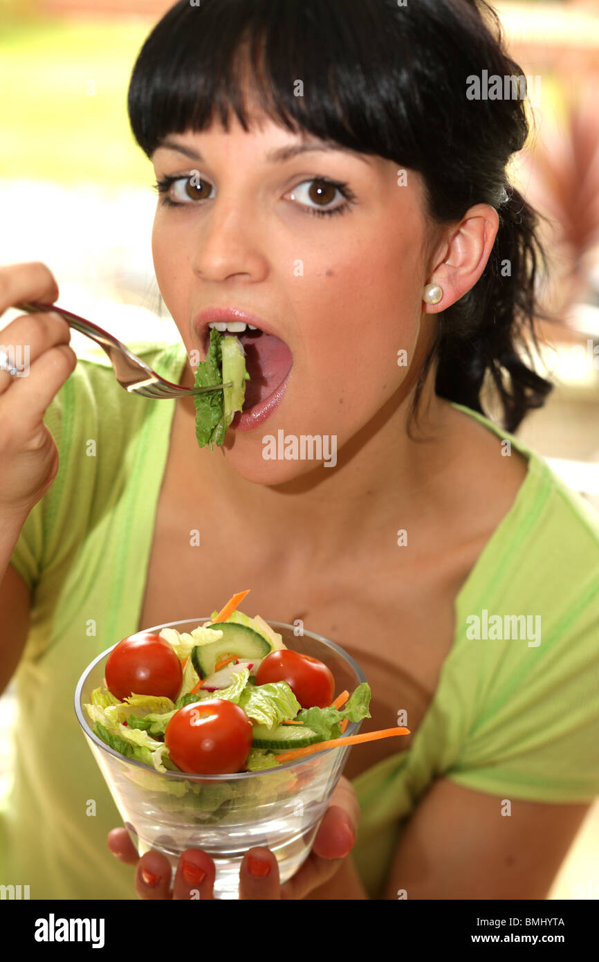 Young Woman Eating Salad. Model Released Stock Photo - Alamy