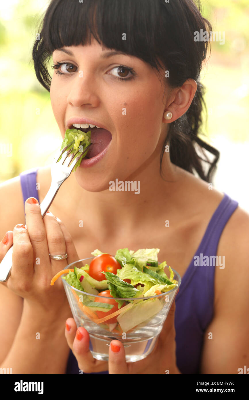 Young Woman Eating Salad. Model Released Stock Photo - Alamy