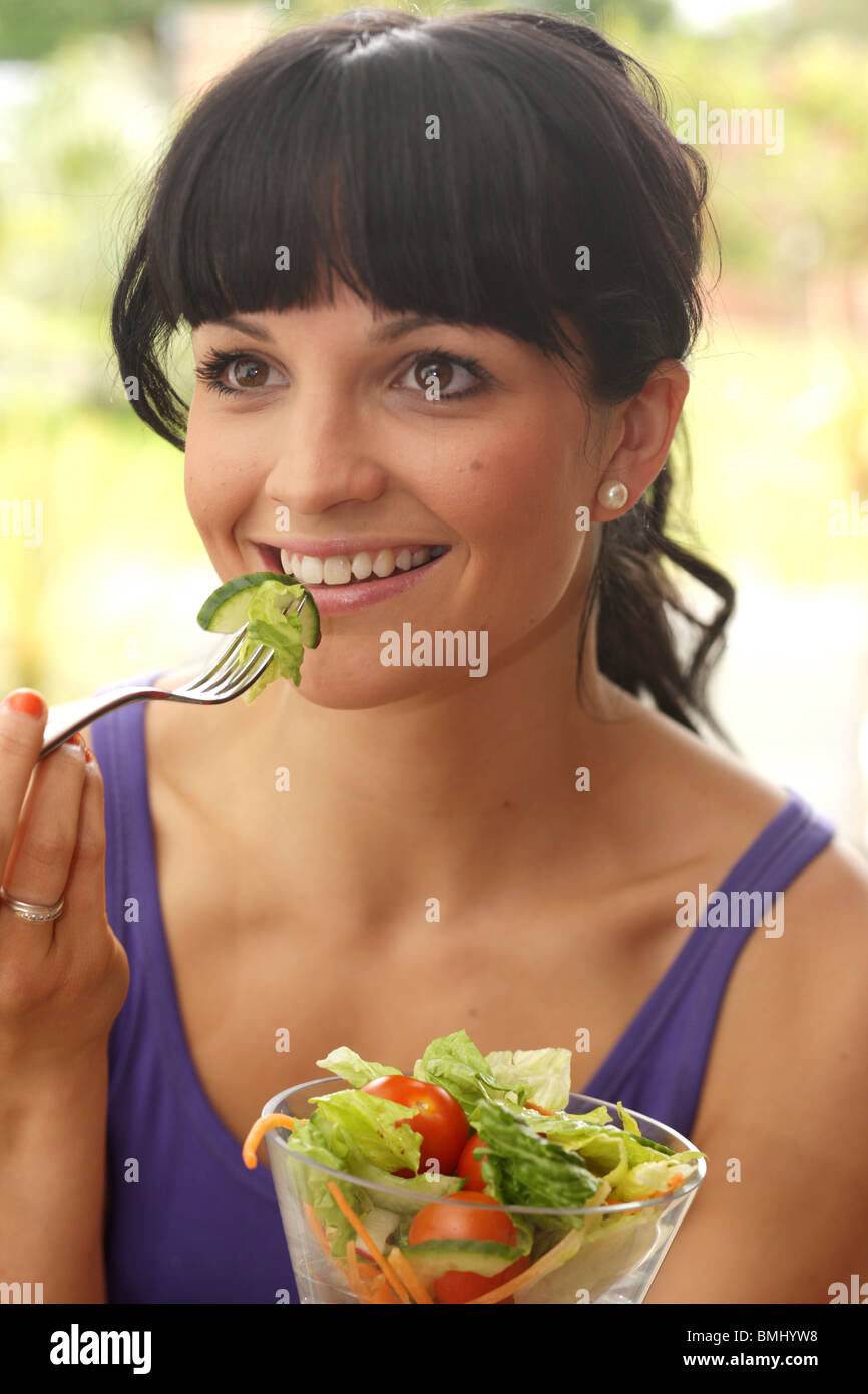 Young Woman Eating Salad. Model Released Stock Photo - Alamy