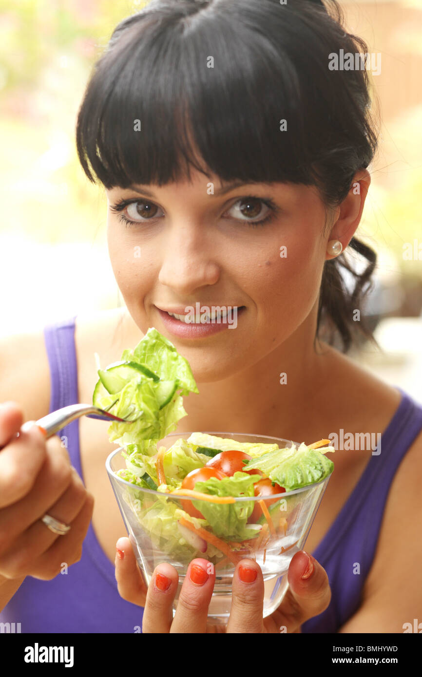 Young Woman Eating Salad. Model Released Stock Photo - Alamy