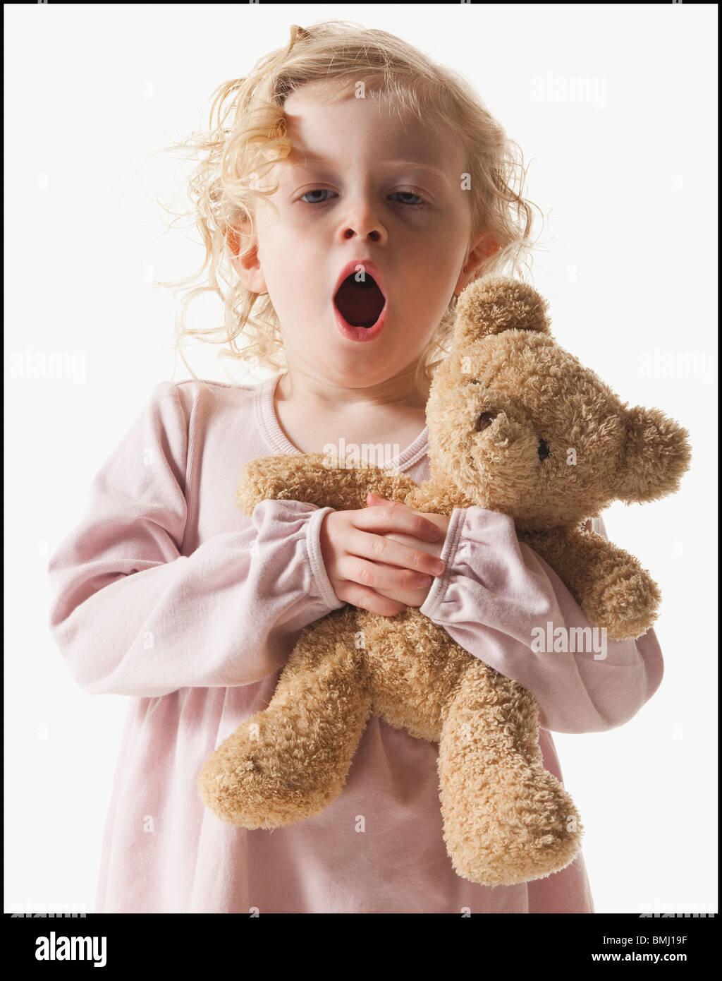 Tired young girl holding teddy bear Stock Photo - Alamy