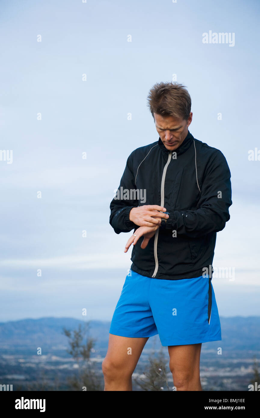 Runner checking watch Stock Photo - Alamy