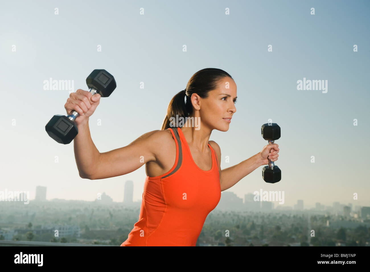 Woman doing weight training Stock Photo - Alamy