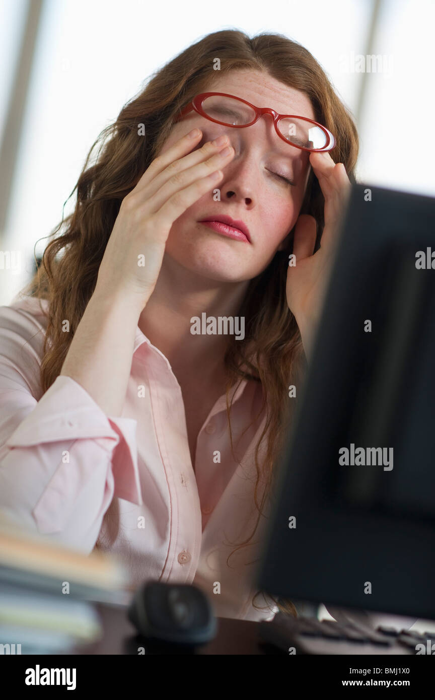 Tired woman working at computer Stock Photo - Alamy