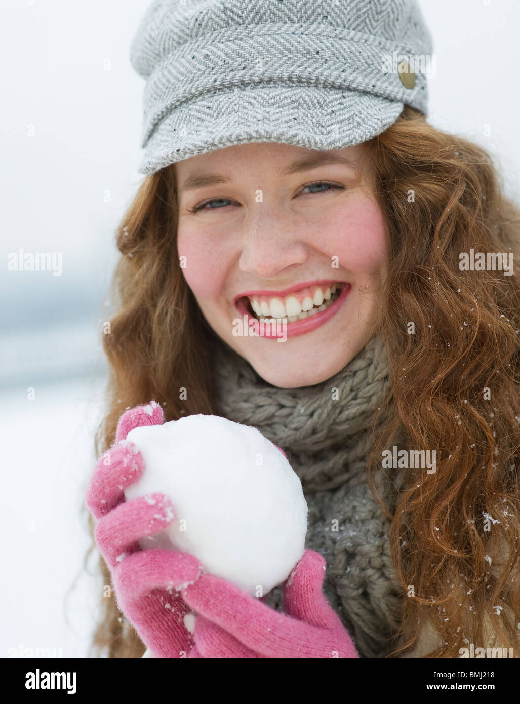 Happy adult woman holding snowballs hi-res stock photography and images ...