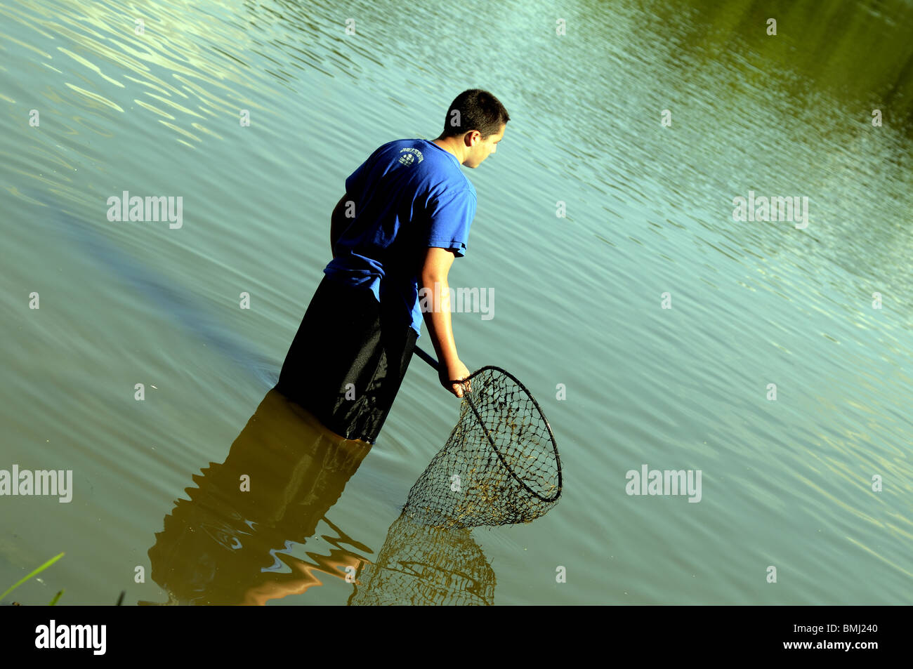 Young man fishing Stock Photo - Alamy