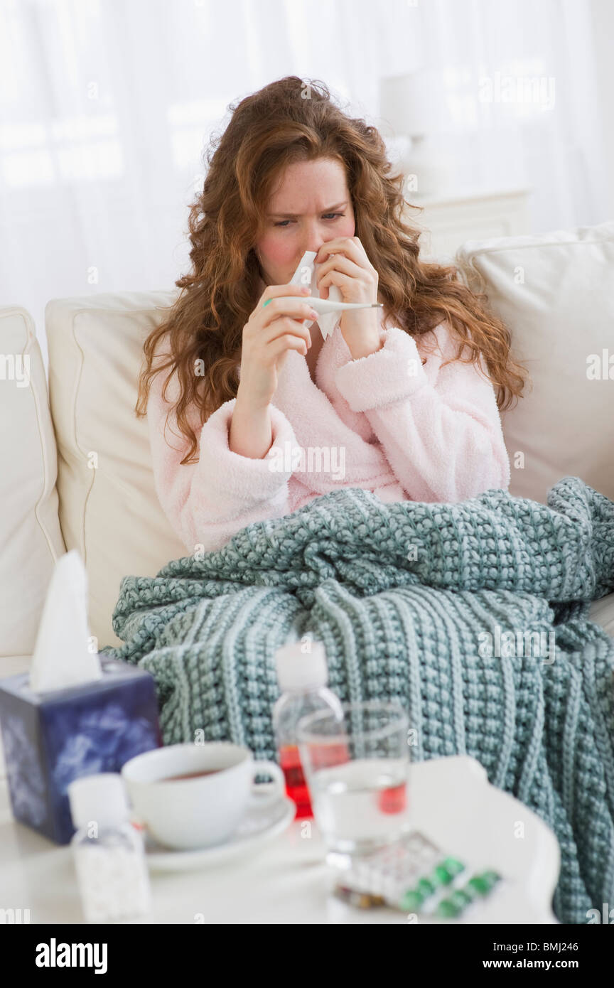 Sick woman on couch Stock Photo - Alamy