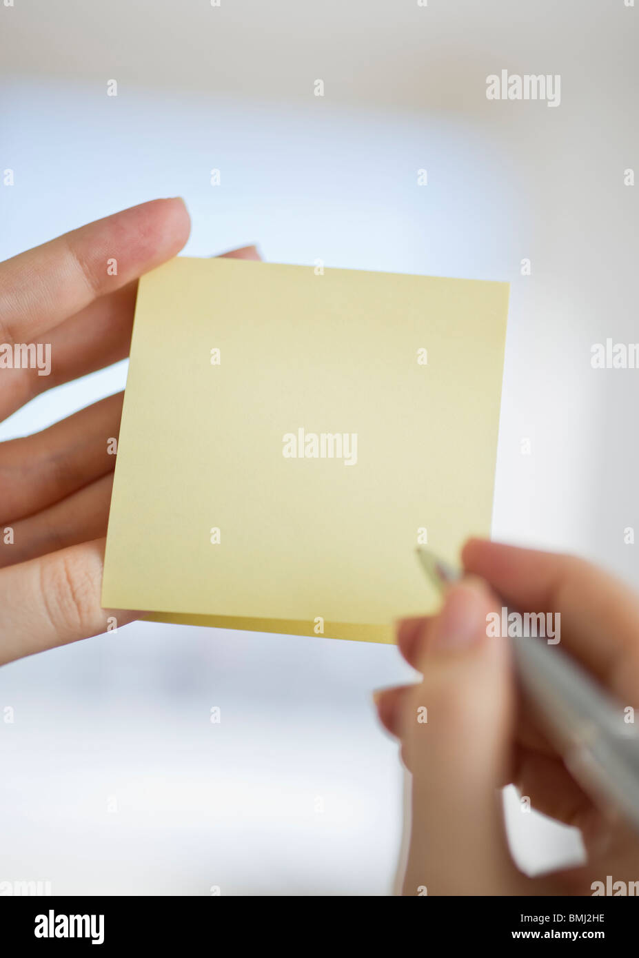 Hands holding notepad and pen Stock Photo - Alamy