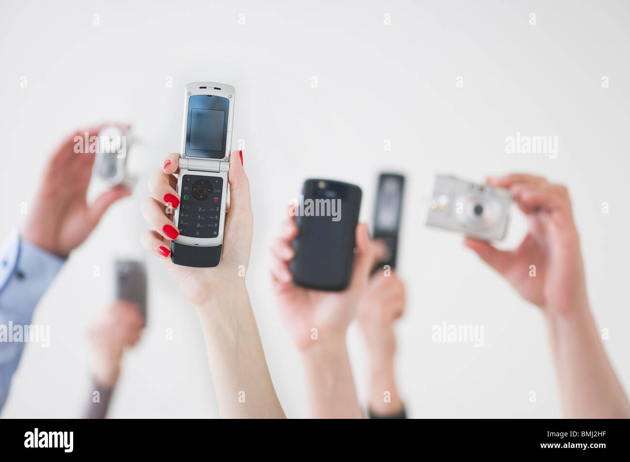 Hands holding wireless devices Stock Photo - Alamy