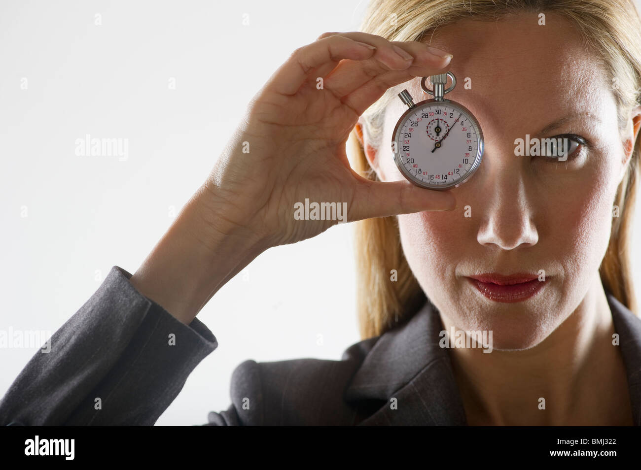Woman holding a stopwatch Stock Photo - Alamy