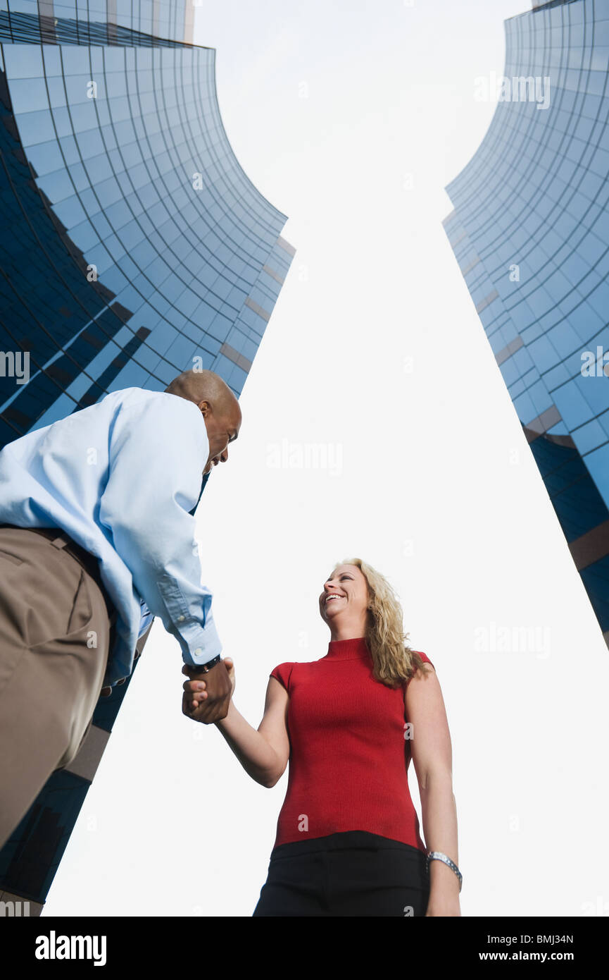 Co-workers shaking hands Stock Photo - Alamy