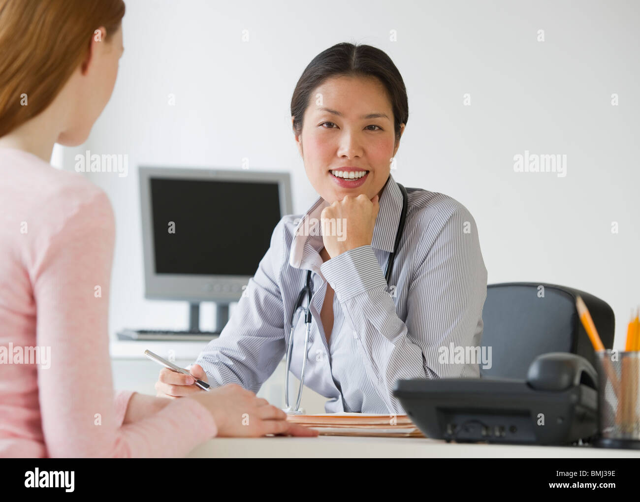Doctor and patient consultation Stock Photo - Alamy