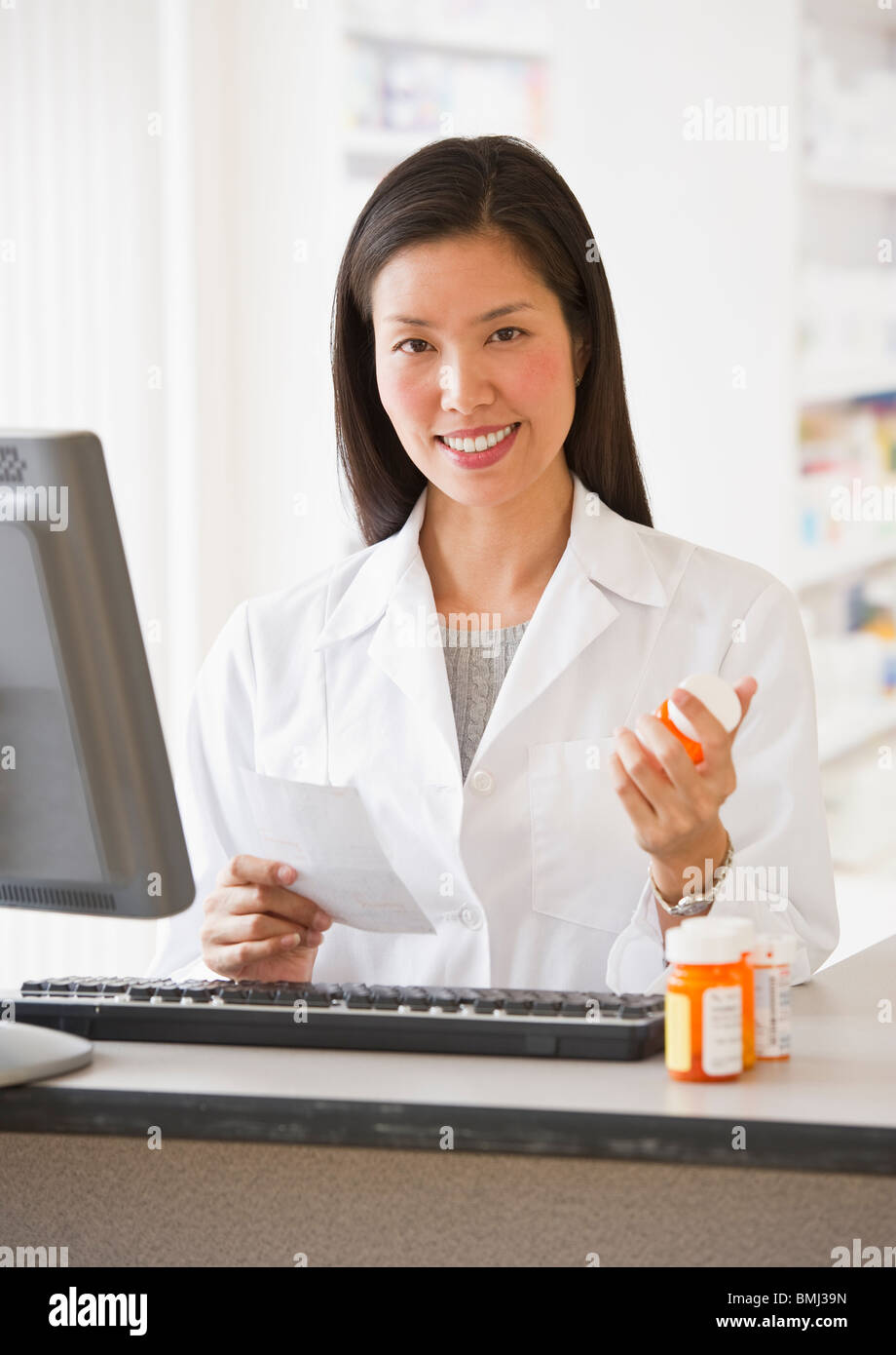 Pharmacist holding prescription medication Stock Photo - Alamy