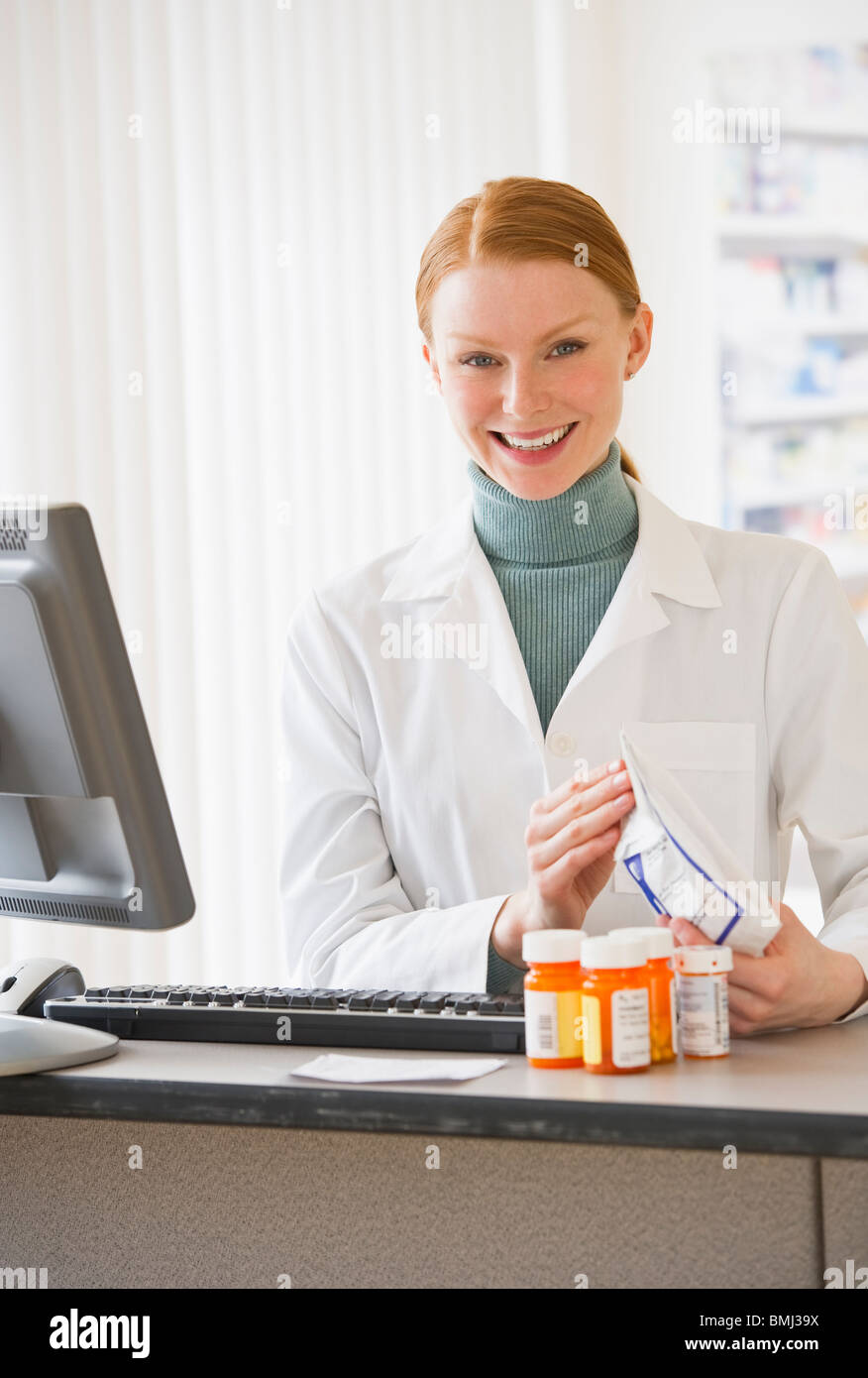 Pharmacist holding prescription medication Stock Photo - Alamy