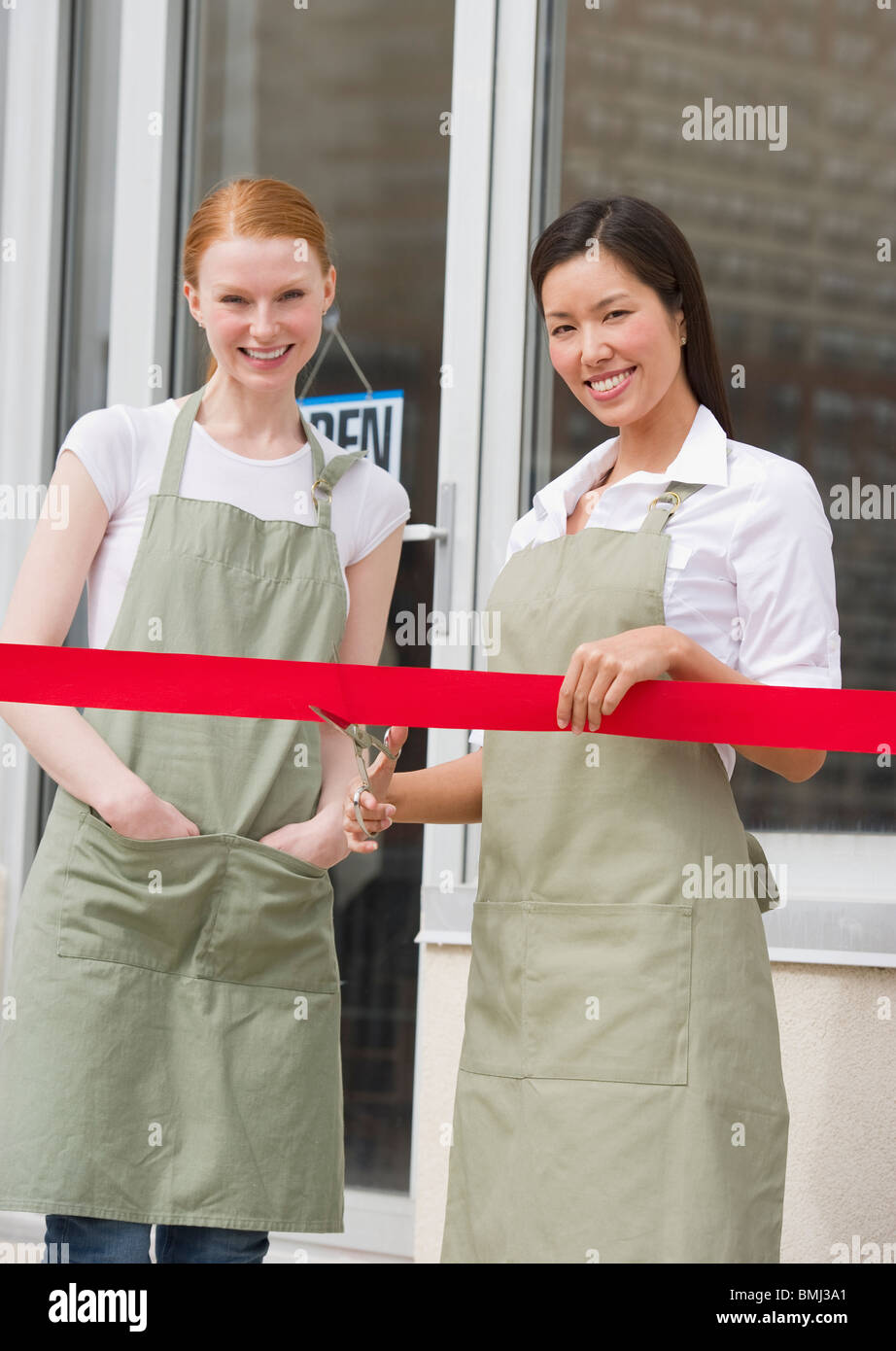 Cutting red ribbon at opening ceremony Stock Photo - Alamy