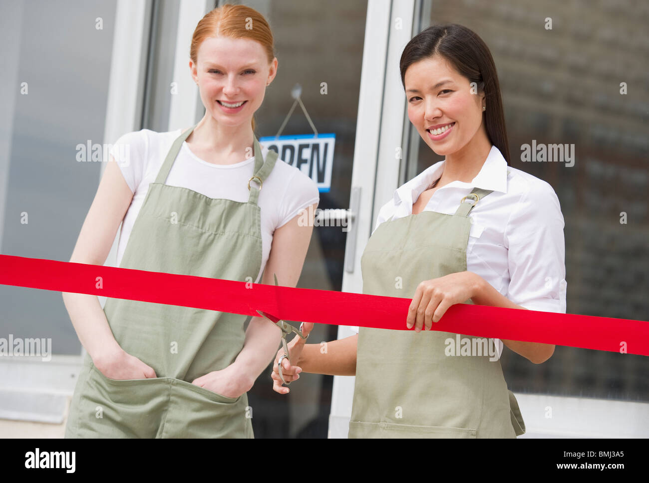 Cutting red ribbon at opening ceremony Stock Photo - Alamy