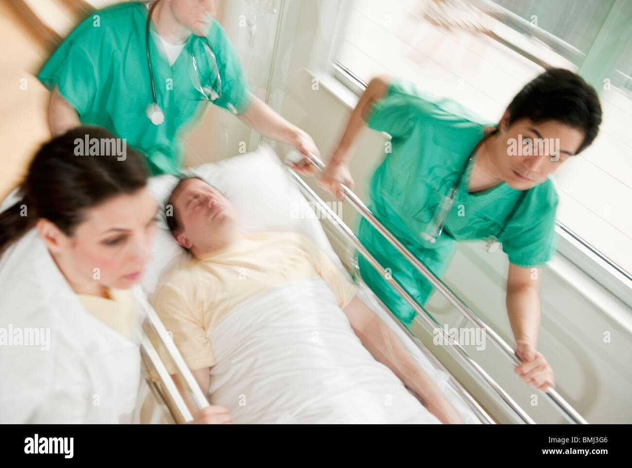 Healthcare workers pushing gurney in emergency room Stock Photo - Alamy