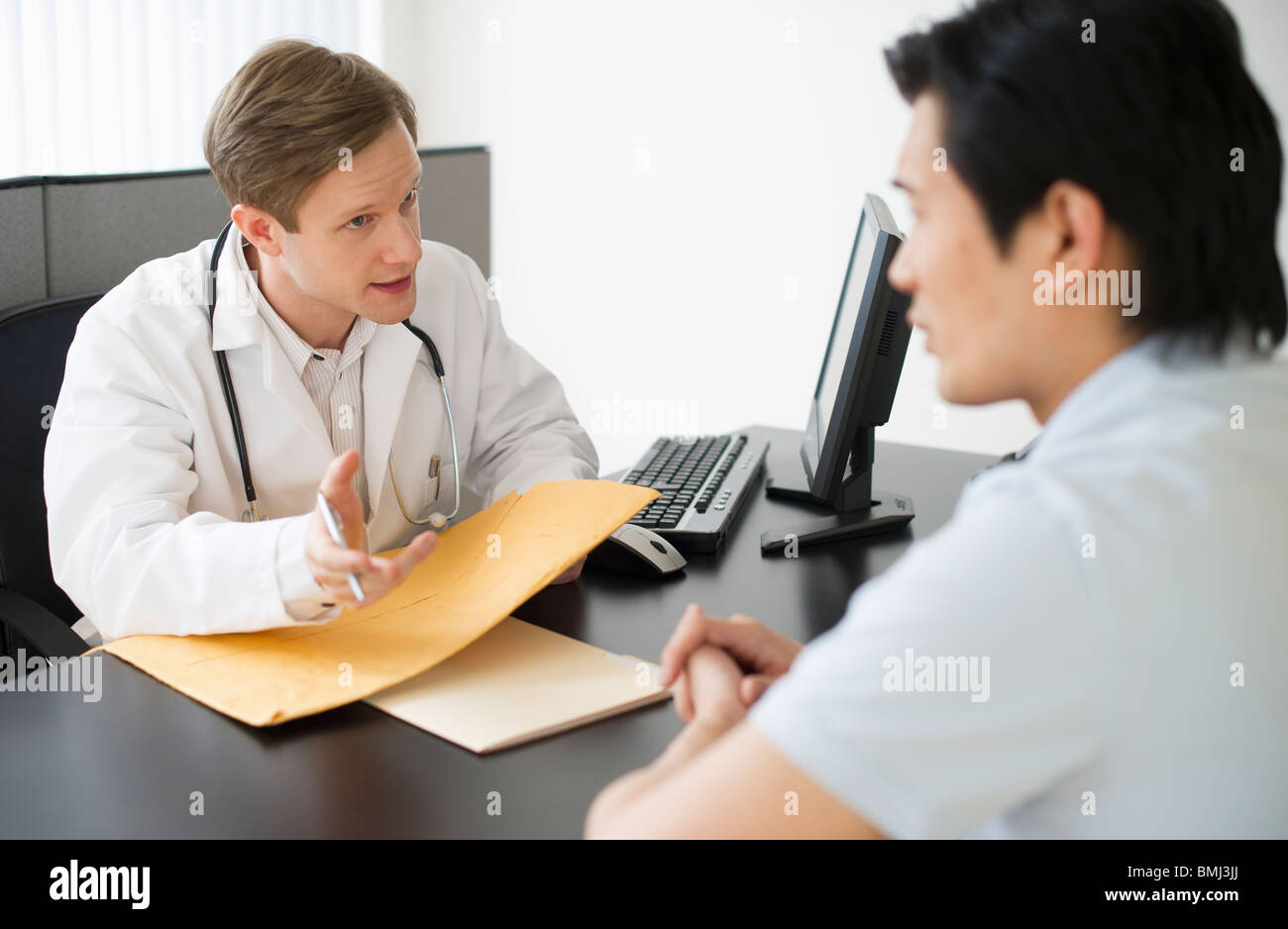 Doctor talking to patient Stock Photo - Alamy