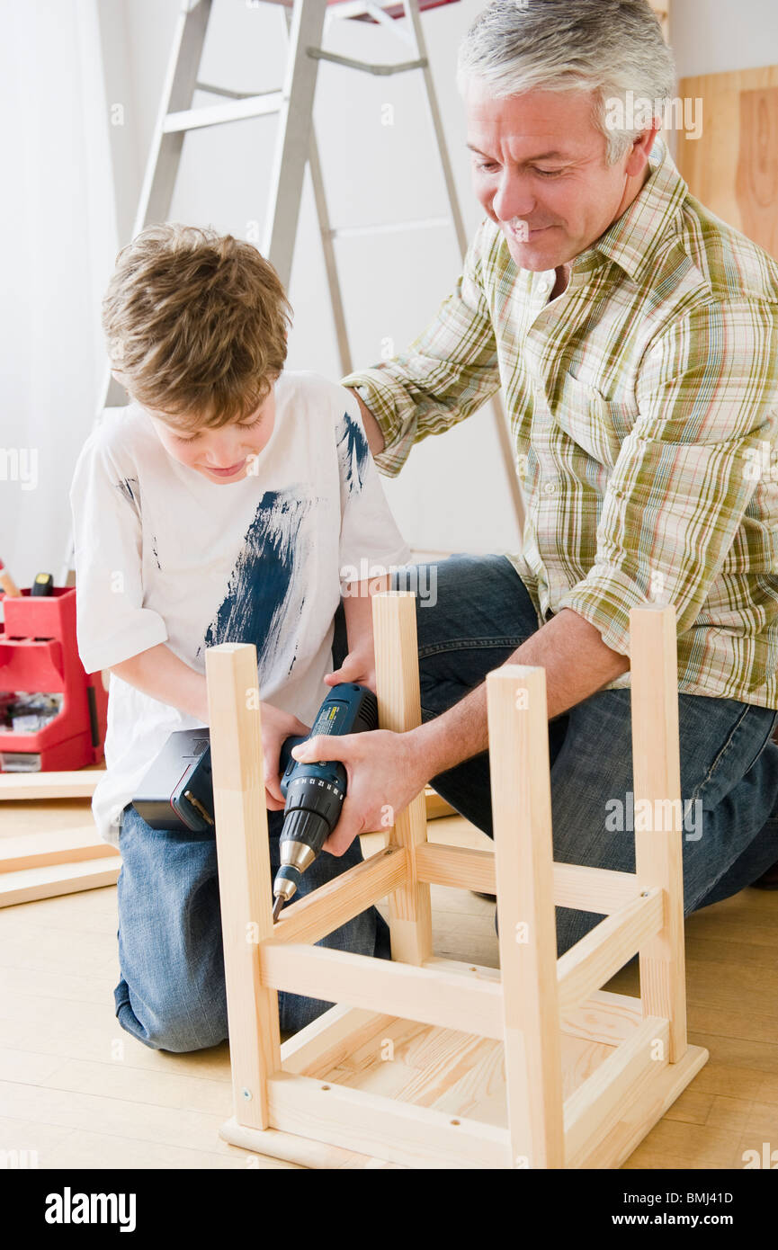 Father and son repairing stool Stock Photo - Alamy